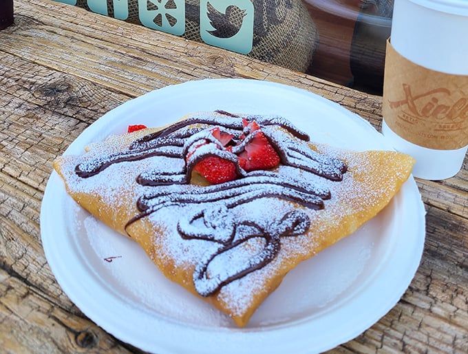 This isn't just a crepe&mdash;it's edible architecture. Chocolate drizzle, fresh strawberries, and powdered sugar create the holy trinity of breakfast indulgence.