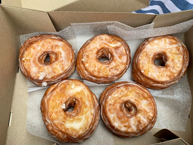 These glazed beauties glisten like they've been kissed by the morning sun. Five perfect rings of happiness, each one promising a moment of pure, unadulterated joy.