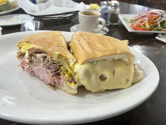 The legendary Cuban sandwich in all its glory—layers of pork, ham, and Swiss cheese pressed between bread that's achieved that mythical crisp-yet-tender harmony.