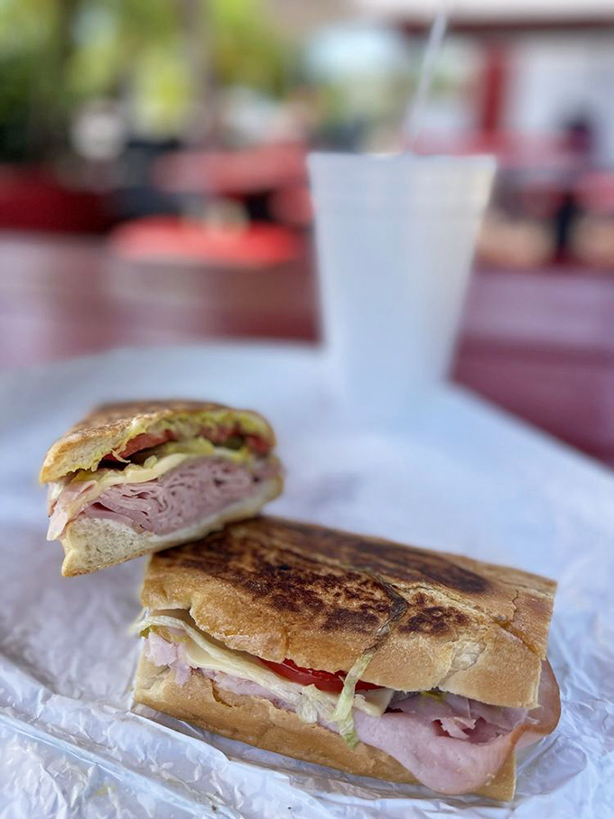 Behold the star of the show! Perfectly pressed Cuban bread showcasing layers of ham, cheese, and pickles that would make Miami jealous.