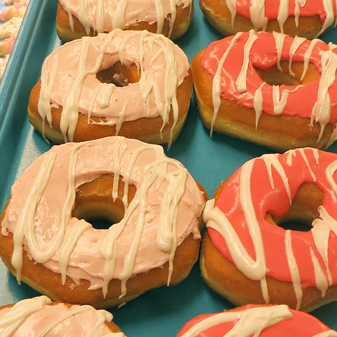 Pink and coral donuts drizzled with white icing&mdash;proof that sometimes the most beautiful art isn't hanging in galleries but sitting in bakery cases.