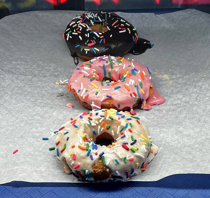 Three perfect circles of joy, each wearing a different party outfit of sprinkles and glaze&mdash;donuts as fashion statements.