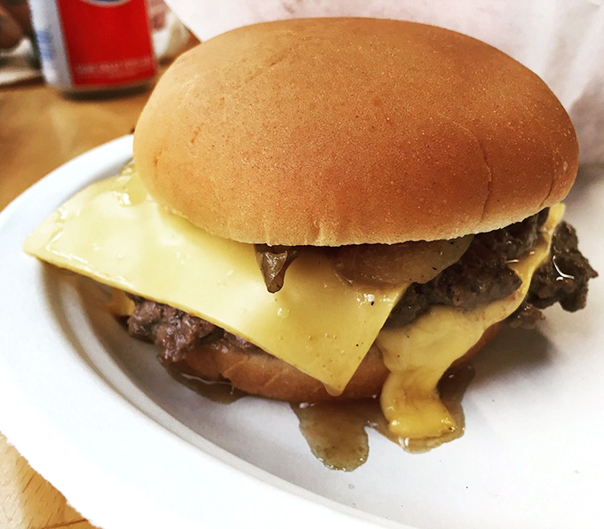 This isn't just a cheeseburger; it's a masterclass in melt, with American cheese cascading over a butter-crisped patty like a golden waterfall.
