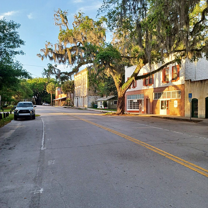 Golden hour transforms Micanopy's main street into a scene straight out of a nostalgic film, where every building has survived enough Florida summers to earn respect.