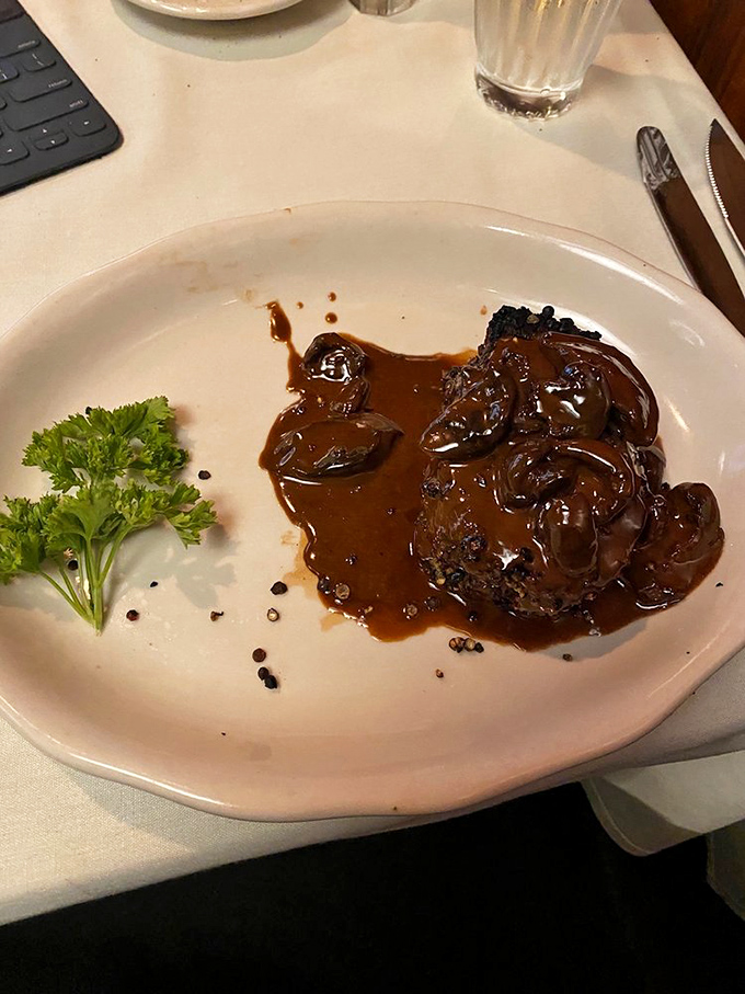 This filet mignon arrives dressed in a glossy sauce that would make Julia Child weep with joy.