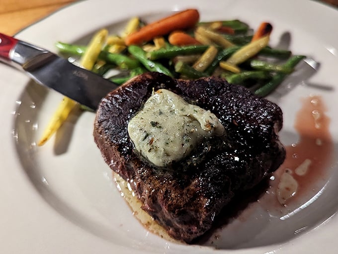 A perfectly seared filet topped with herb butter melts like a summer day, while colorful vegetables add both nutrition and alibi.