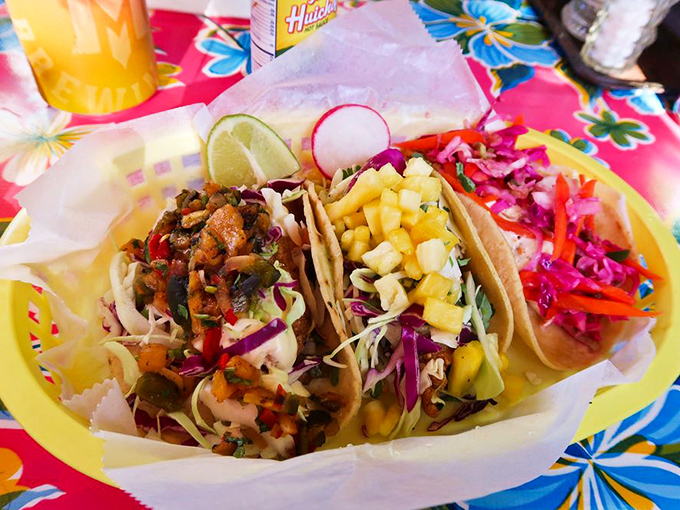 These tacos don't just sit there looking pretty—they demand to be devoured, with toppings cascading like a colorful flavor waterfall.