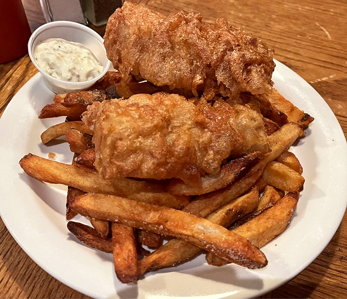 Golden-battered fish perched atop a mountain of proper chips &ndash; this isn't fast food, it's a slow-down-and-savor masterpiece.
