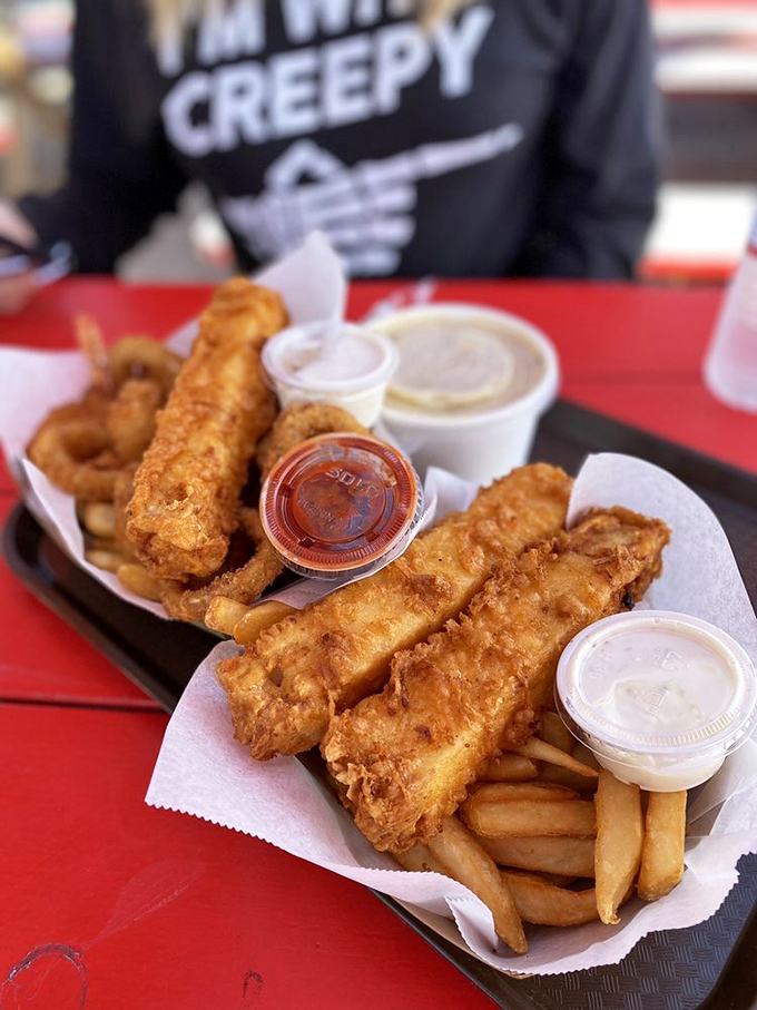 Golden-battered fish that shatters with each bite, paired with perfectly crisp fries. This isn't just fish and chips&mdash;it's edible sunshine on a paper-lined tray.