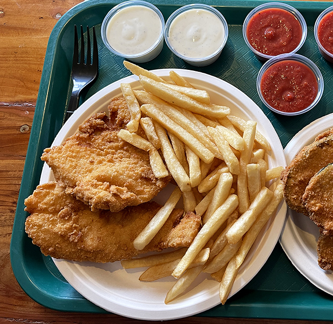 Golden-battered fish resting alongside perfectly crisp fries&mdash;proof that sometimes the simplest combinations are culinary perfection.