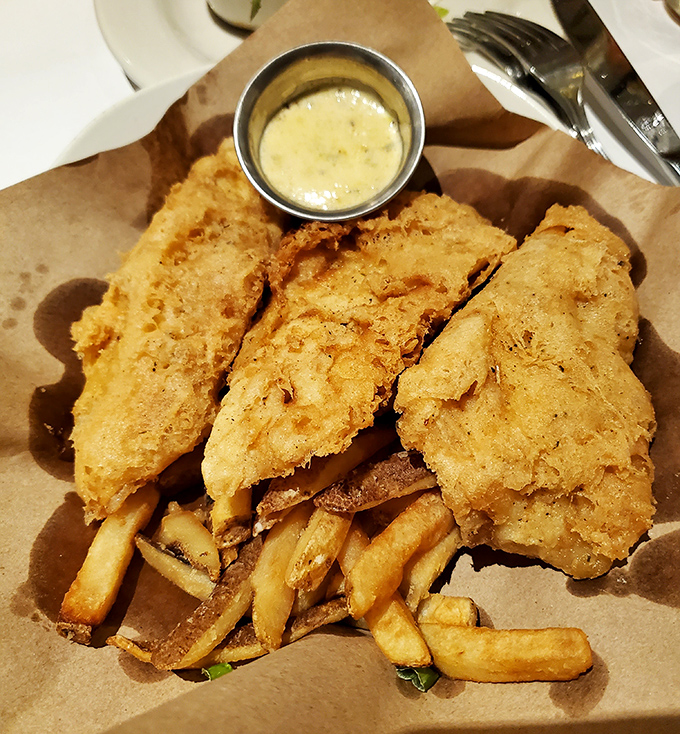 Golden-battered fish resting on a bed of crispy fries &ndash; this isn't just fish and chips, it's what fish dreams of becoming when it grows up.