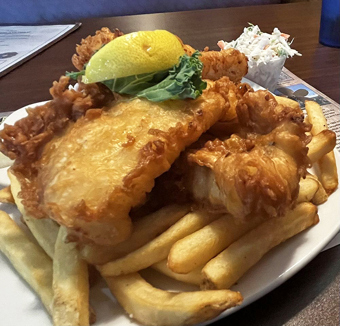 Golden-battered fish perched atop a mountain of fries. This isn't just fish and chips&mdash;it's edible sunshine with a side of happiness.