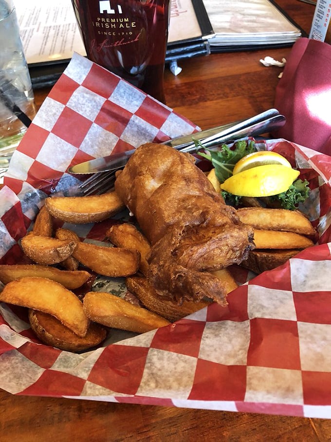 Golden-battered fish and chunky chips served in a red checkered basket&mdash;proof that simplicity, when done right, is the ultimate sophistication.