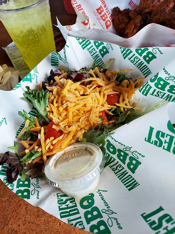 Not your average garden salad! Crisp greens crowned with shredded cheddar and fresh tomatoes prove vegetables can find happiness at a barbecue joint.