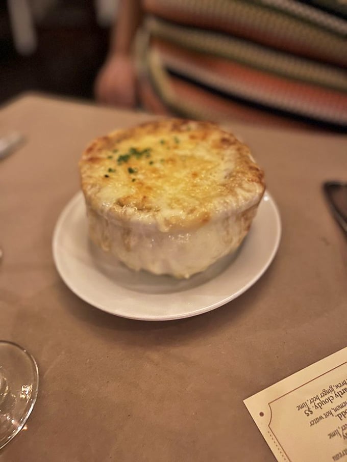 Behold the star attraction: French onion soup with a cheese canopy so perfectly bronzed it deserves its own modeling contract.