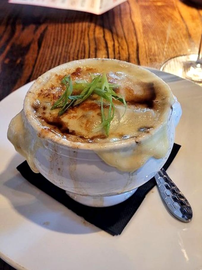 The legendary French onion soup in all its glory &ndash; that cheese pull could win Olympic medals. A bubbling cauldron of comfort that's worth every savory, soul-warming spoonful.