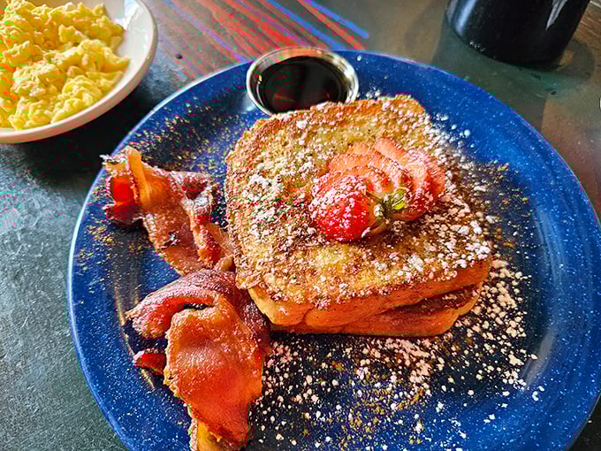 French toast that deserves its own fan club, dusted with powdered sugar and served with perfectly crisp bacon&mdash;breakfast doesn't get more photogenic than this.