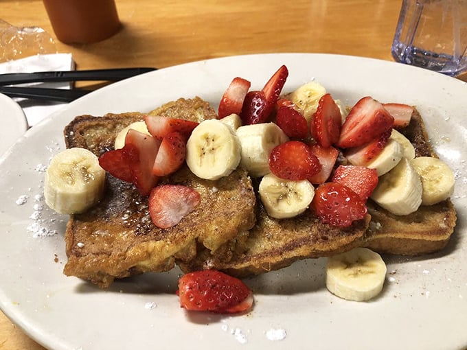 French toast that doesn't just arrive&mdash;it makes an entrance, crowned with fresh strawberries and bananas like breakfast royalty.