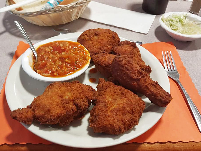 Golden-brown perfection meets tangy hot sauce in a dance as old as time. This isn't just fried chicken; it's edible history with a side of joy.