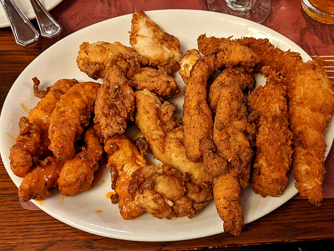 Behold the legendary chicken tenders that have launched a thousand road trips. Golden, crispy perfection that makes grown adults negotiate for the last piece.