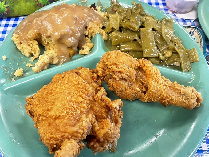 Golden-brown chicken with a crust that shatters like glass, cornbread that crumbles just right, and collard greens cooked with reverence&mdash;this is Alabama on a plate.