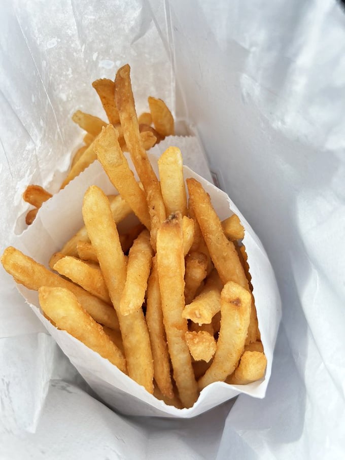 Golden perfection in paper&mdash;these aren't just french fries, they're crispy potato masterpieces that make you question every other fry you've ever eaten.