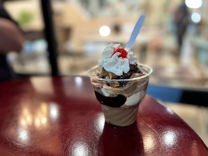 Layer upon layer of creamy custard, chocolate sauce, and whipped cream. This isn't just dessert&mdash;it's architecture with a cherry on top.