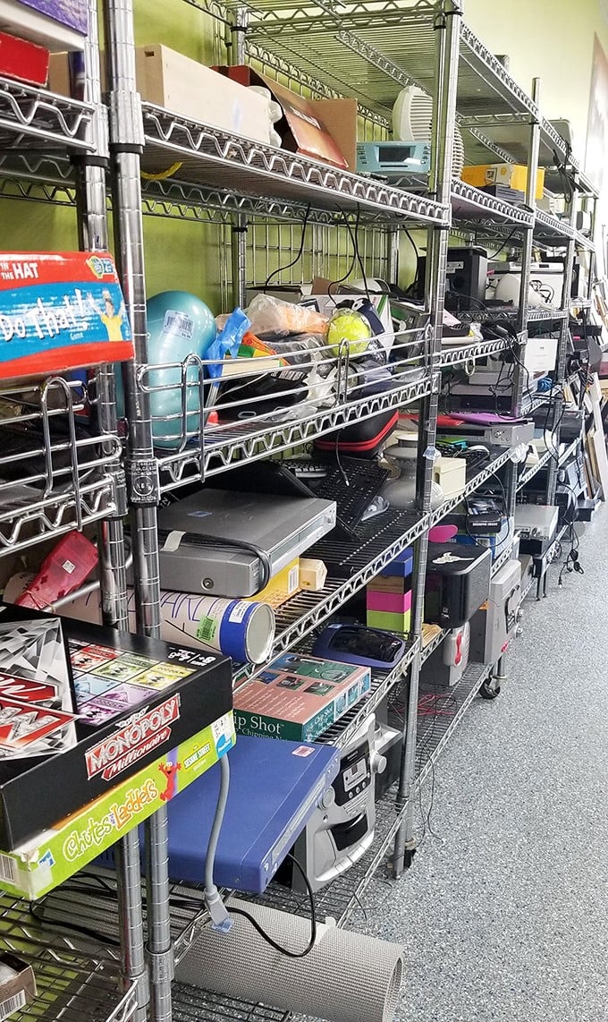 Electronic gadgets, board games, and forgotten tech create a time capsule of American leisure. Spot the Monopoly box waiting for its second chance at family game night.