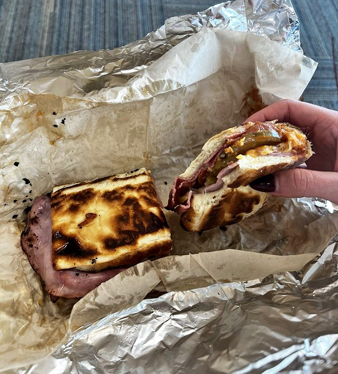 Not all heroes wear capes; some come wrapped in foil. The Garbage Grinder reveals its glorious layers like a delicious archaeological dig.