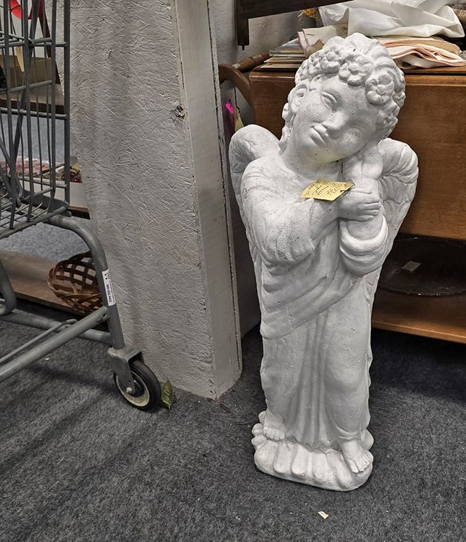 Garden angels waiting for their forever homes. This contemplative cherub has probably witnessed more shopping decisions than a fitting room attendant.