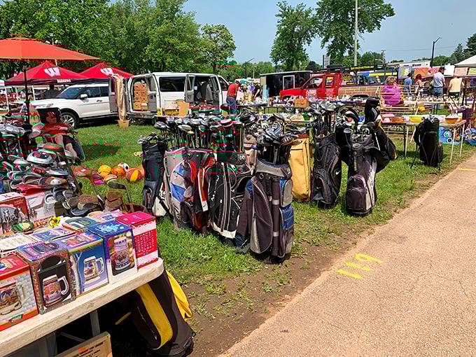 Golf bags gathered like old friends at a reunion, ready to help someone perfect their weekend slice.
