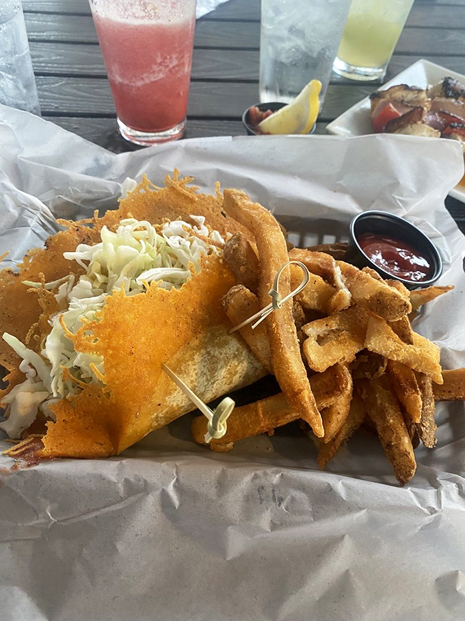 Golden-fried perfection nestled in a basket with crispy fries &ndash; this grouper taco delivers Florida's signature fish with a crunch that echoes through paradise.