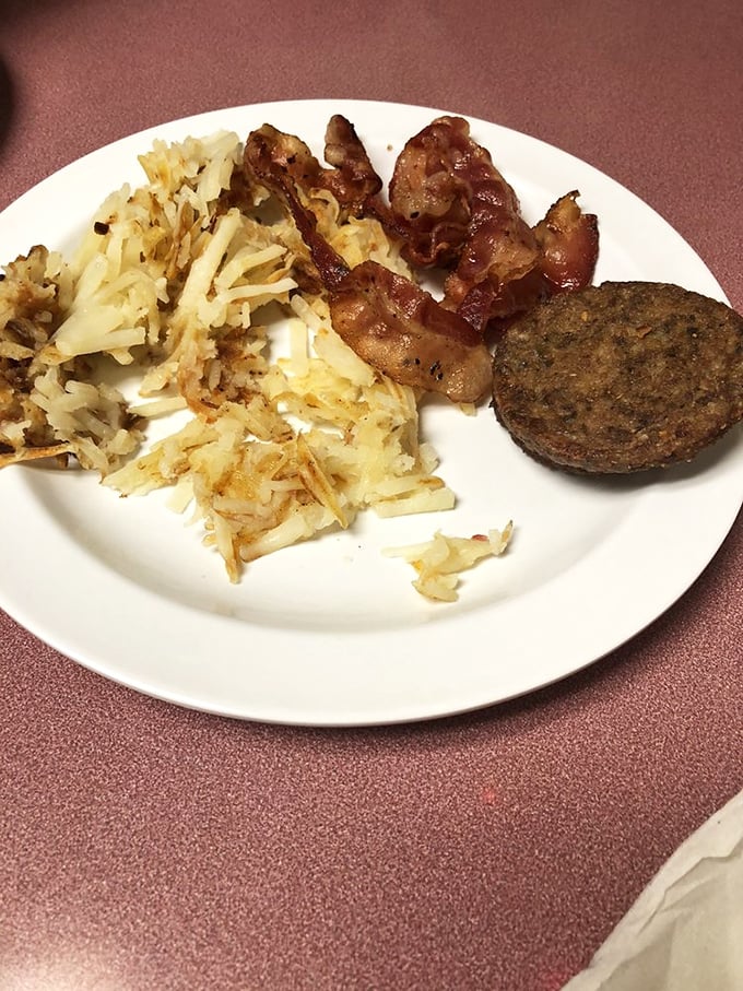 Hash browns that deserve their own fan club. Crispy, golden perfection sharing a plate with bacon that clearly didn't skip its morning workout.