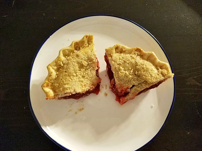 Two slices of ruby-red pie with crumb topping sit like edible jewels. This isn't just dessert&mdash;it's the reason elastic waistbands were invented.