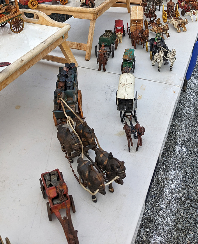 Miniature horse-drawn wagons line a vendor's table, each tiny wooden wheel carrying the craftsmanship of a bygone era when toys were built to last generations.
