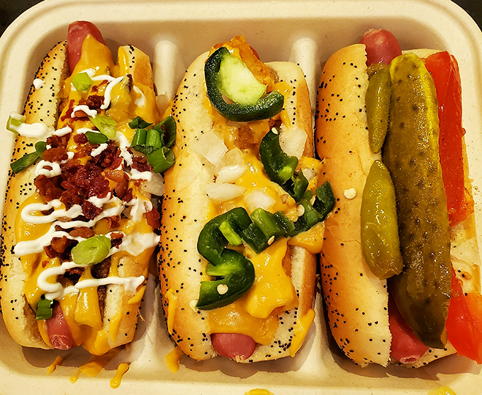 These aren't your ballpark dogs&mdash;they're culinary canvases where toppings become art, proving that perfection sometimes comes nestled in a poppy seed bun.