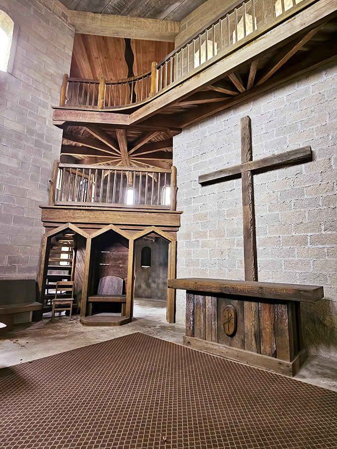 Sacred meets medieval in this stunning interior space, where wooden craftsmanship creates multiple levels connected by rustic staircases and bathed in natural light.