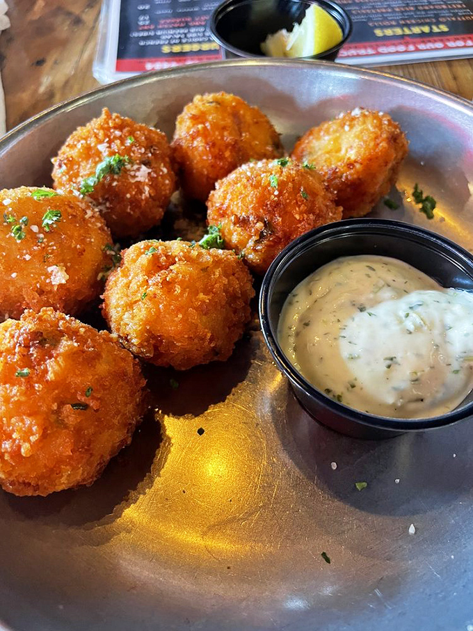 Golden-fried spheres of joy that crunch with purpose, revealing a molten interior that makes you question why you'd ever waste time on lesser appetizers.
