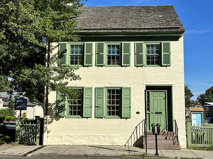 Crisp green shutters against cream-colored brick&mdash;this historic home doesn't just preserve history, it wears it with understated elegance.