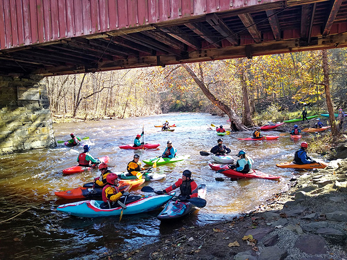 Kayakers navigate the creek's currents beneath the historic bridge, proving that social distancing was cool before it was mandatory.