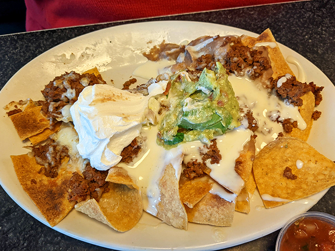 Nachos architecture 101: Perfect structural integrity ensures every chip bears its fair share of beef, cheese, sour cream, and guacamole glory.