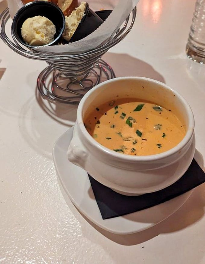 This lobster bisque isn't just soup; it's a warm embrace in a bowl. The artful presentation with fresh herbs and crusty bread elevates comfort to luxury.