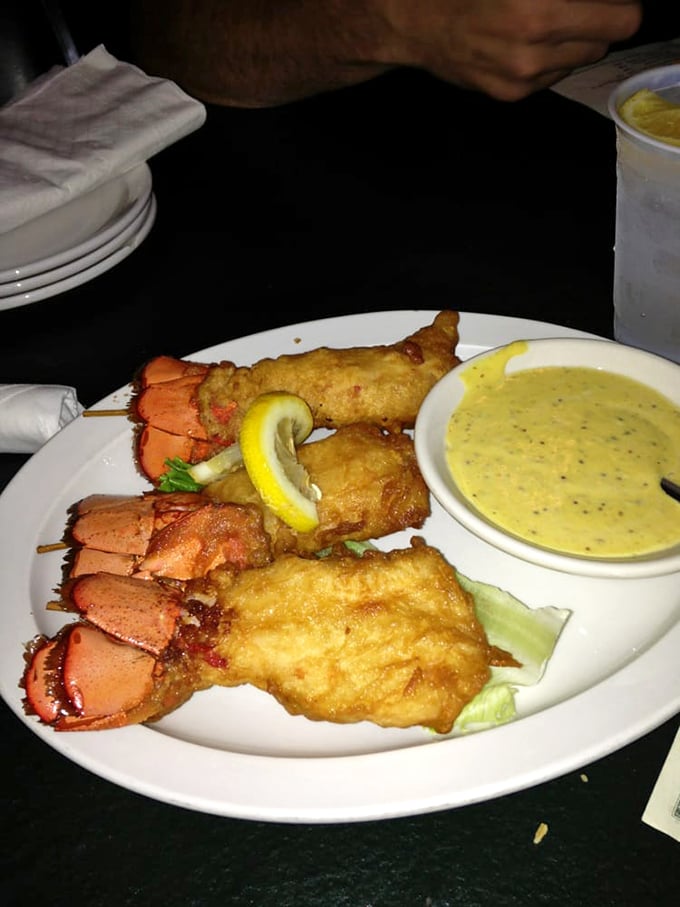 Golden-fried lobster tails that make you question why you ever bothered with the fancy restaurants. That dipping sauce deserves its own fan club.
