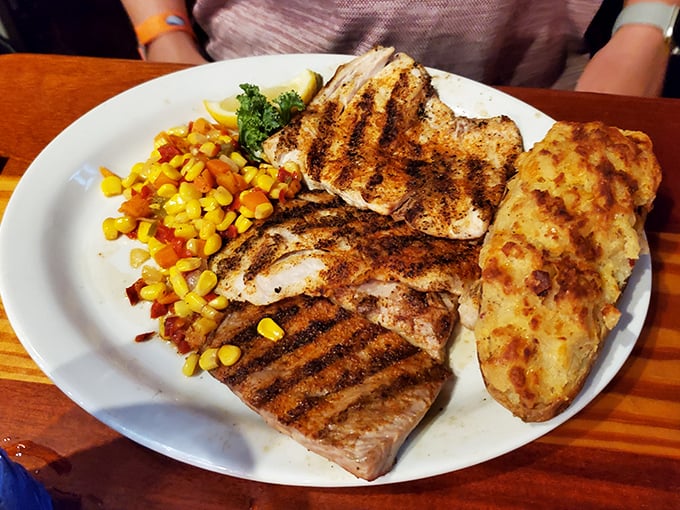 Behold the star of the show: perfectly grilled Mahi-Mahi alongside sweet corn and a baked potato that's practically begging to be devoured.