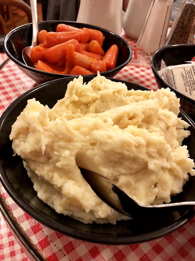 Comfort food 101: Creamy mashed potatoes and glazed carrots served family-style. No need to raise your hand for seconds.