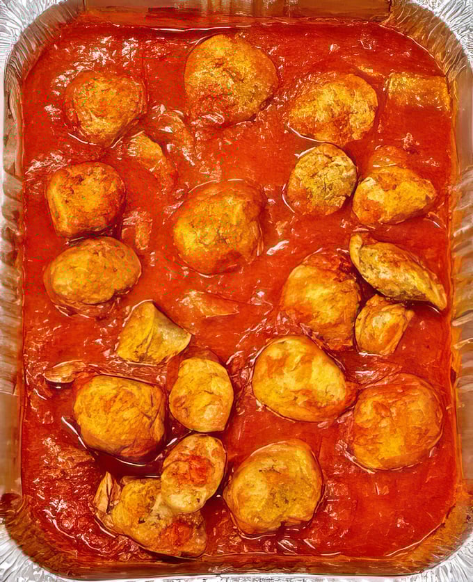 These aren't just meatballs; they're edible time machines swimming in a sea of tomato glory, transporting you straight to a Sicilian grandmother's kitchen.