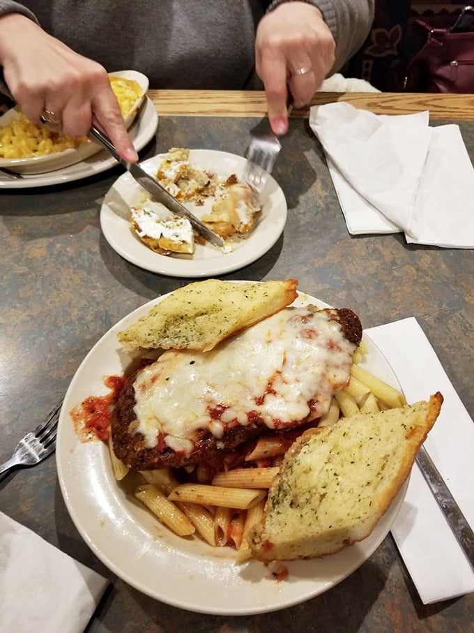 Behold the star attraction: Charlie's legendary meatloaf, smothered in melted cheese and marinara, served with pasta and garlic bread that demands to be devoured.