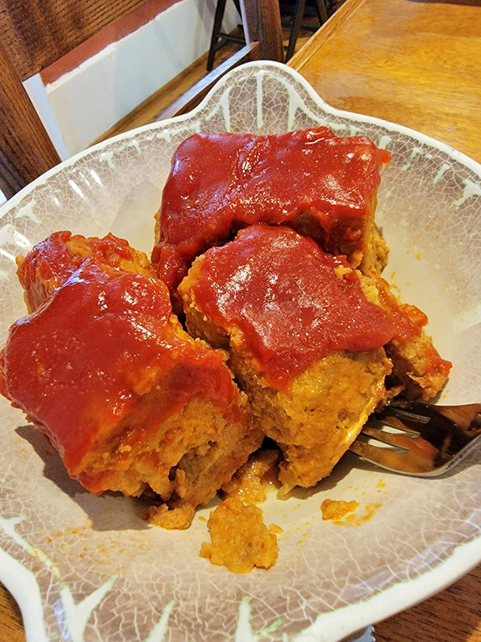 This meatloaf isn't just comfort food&mdash;it's a hug on a plate, glistening with tangy tomato glaze that makes taste buds stand at attention.