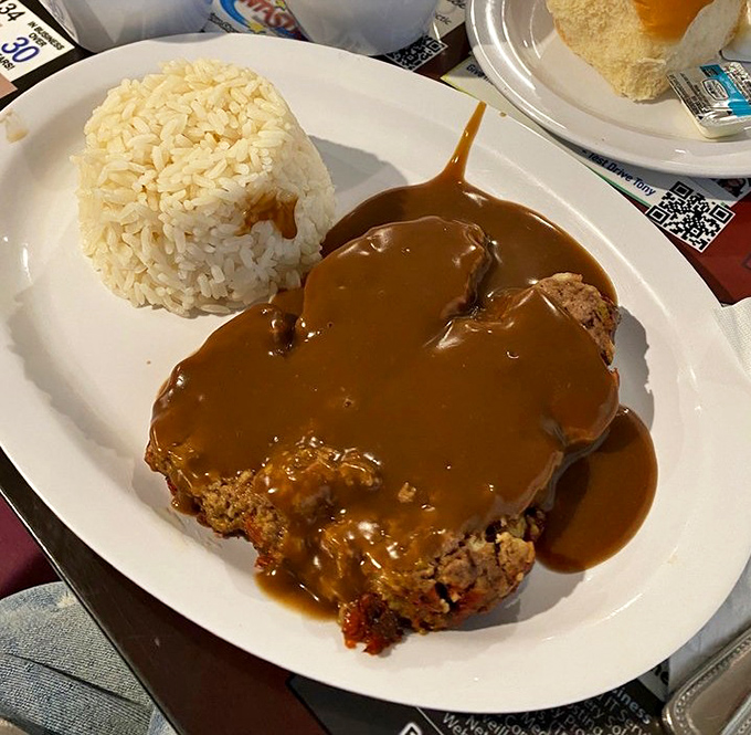 That meatloaf isn't just covered in gravy &ndash; it's swimming in a lake of savory goodness that makes you want to grab a snorkel.