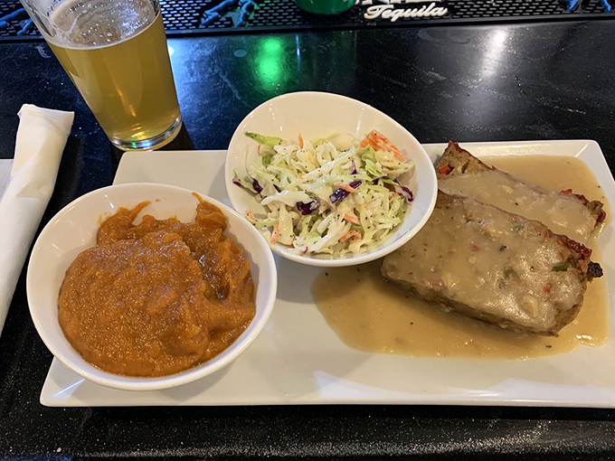 That, my friends, is meatloaf nirvana – bathed in savory gravy alongside sweet potato perfection and cole slaw that didn't come from a plastic tub.